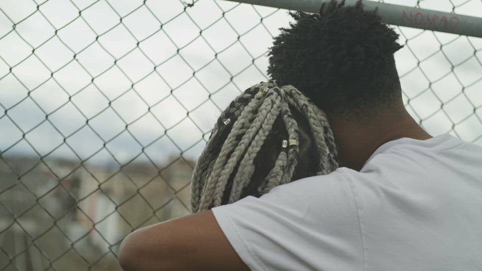 Guy Puts Arm Around Girl By Chain Link Fence Stock Video Footage